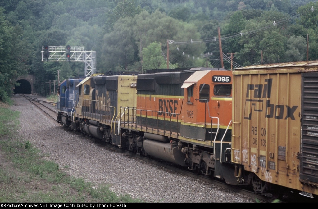 A westbound freight is about to plunge into the tunnel's darkness